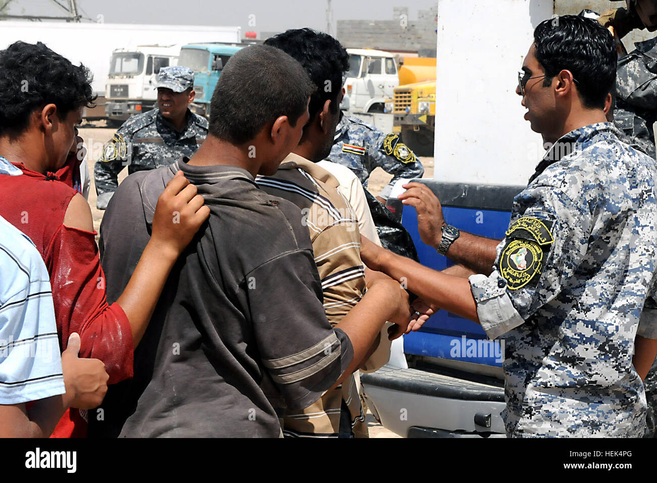 Policemen assigned to 1st Federal Police hand out food rations to a ...