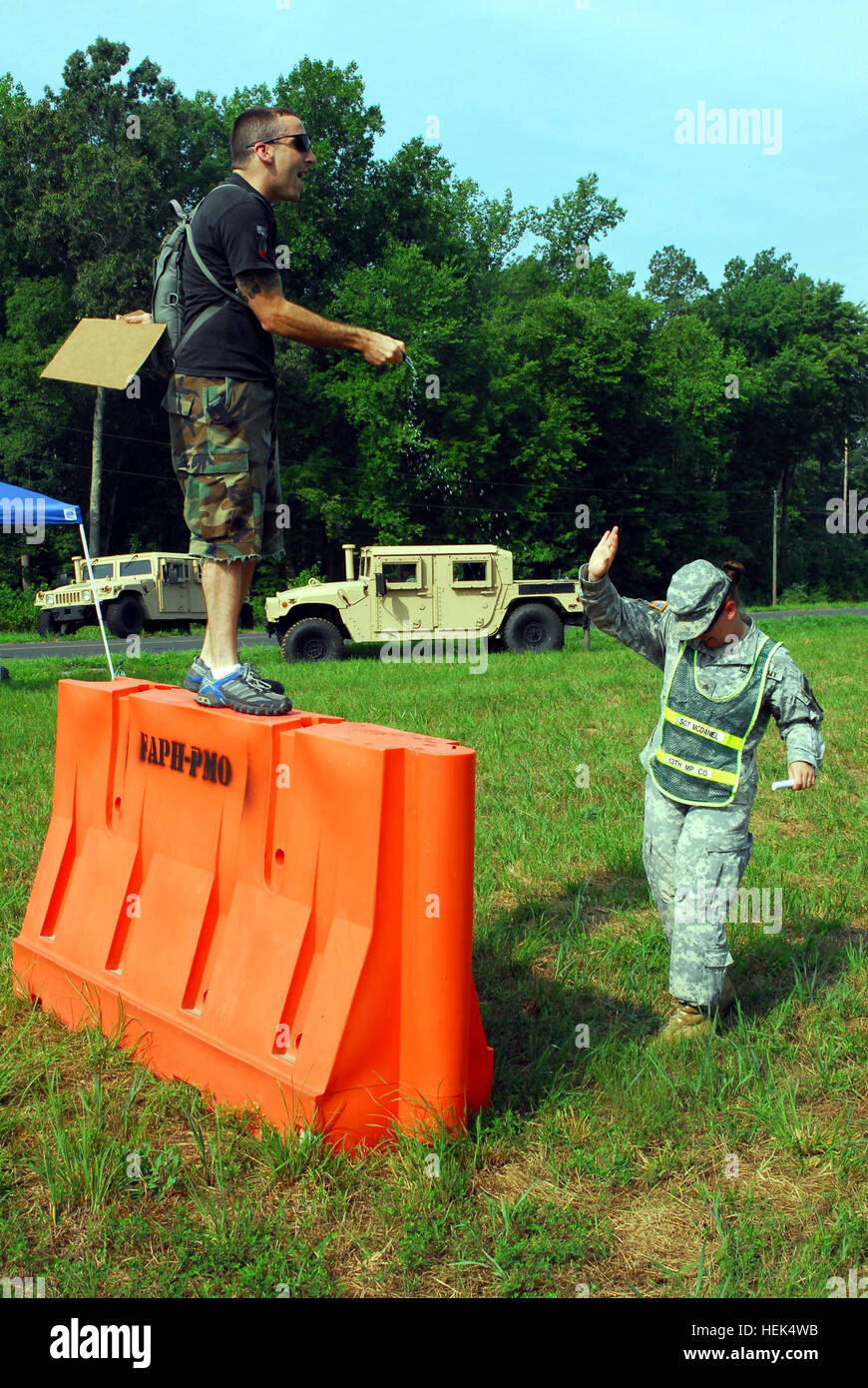 A National Guard infantry Soldier sprays a military police officer with ...