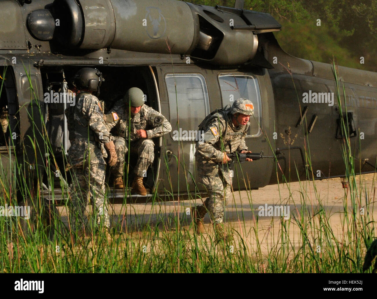 Spc. Derek Michael exits a UH-60 Blackhawk during a helicopter ...