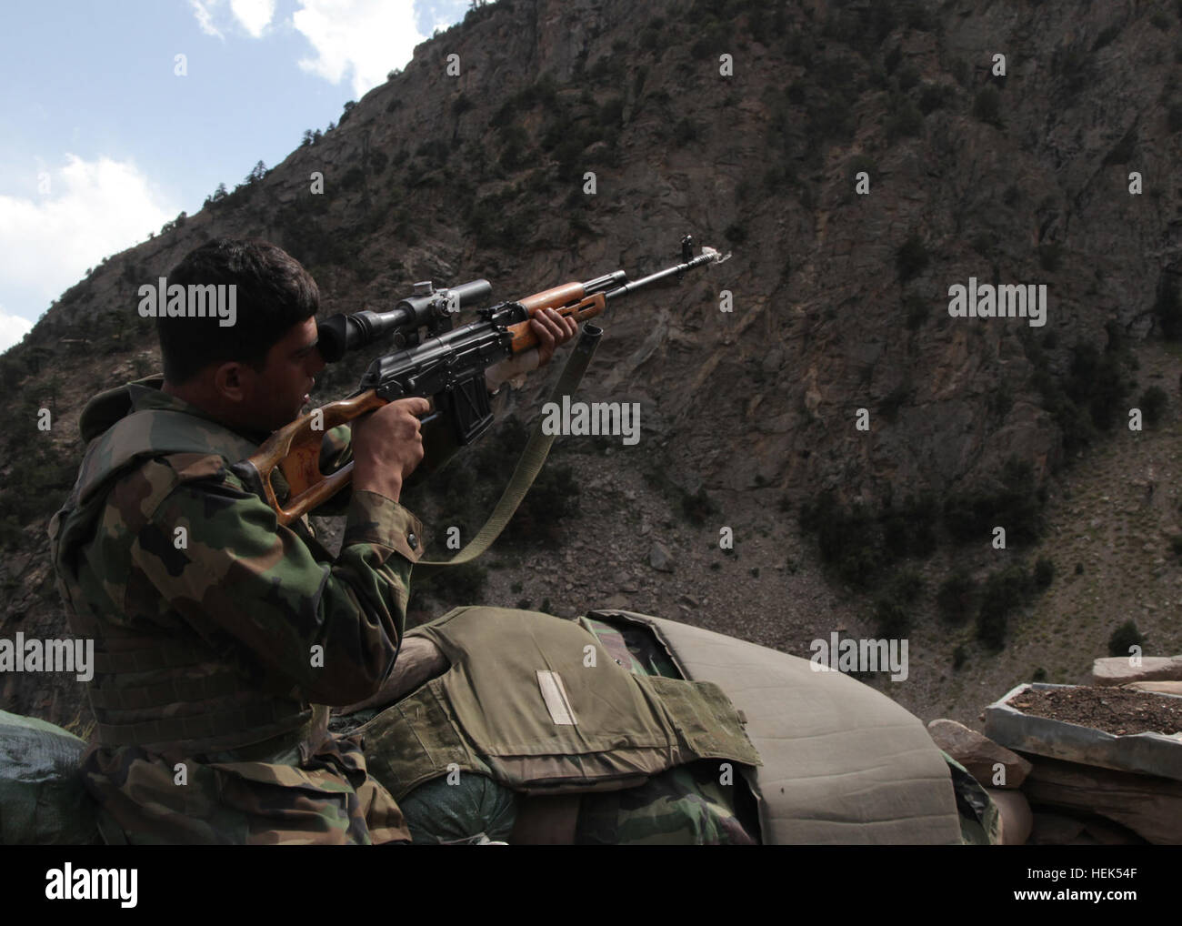 An Afghan National Army (ANA) soldier with the 201st ANA Corps aims a ...