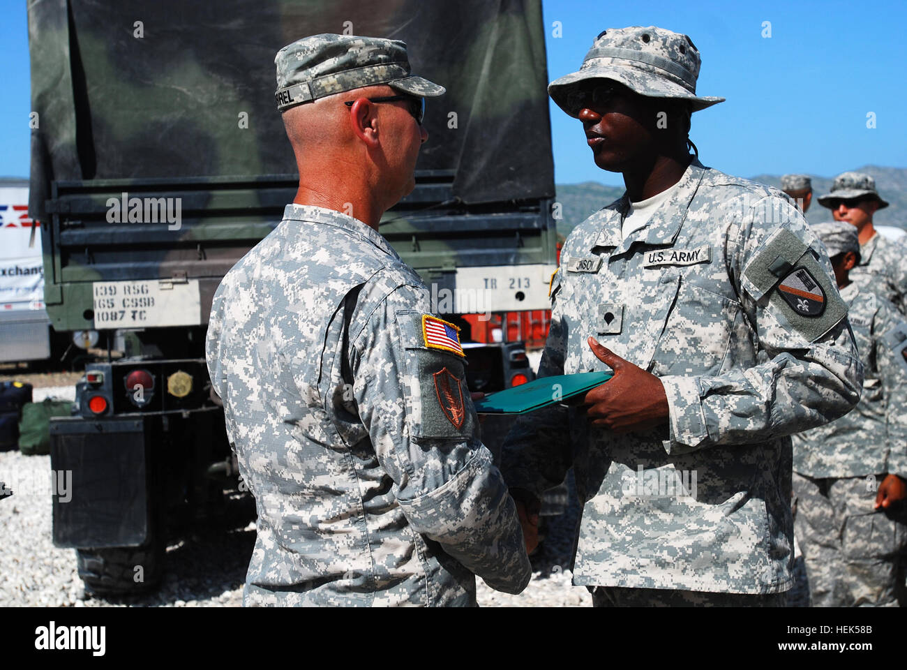Task Force Kout Men Commander Col. Michael Borrel awards an Army ...