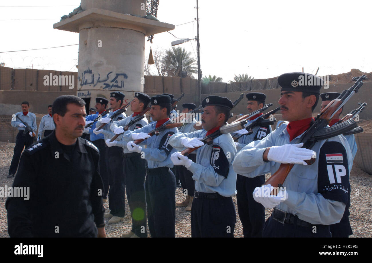An Iraqi police captain inspects a line of Iraqi policemen practicing ...