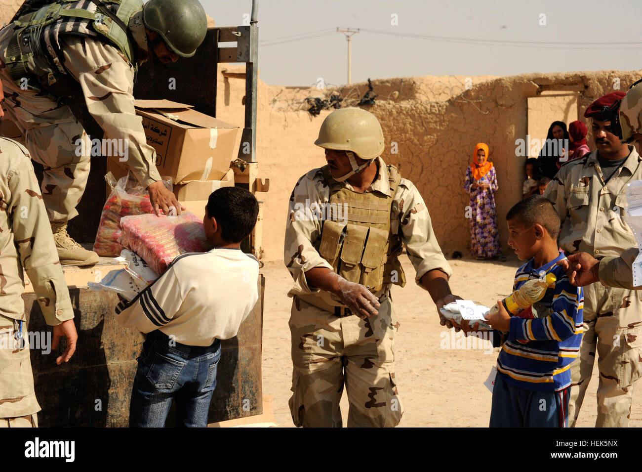 Iraqi children receive food from Iraqi Army soldiers in a small village ...