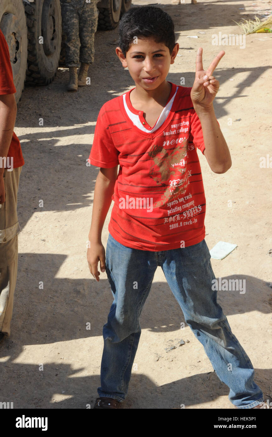An Iraqi boy poses for a photo during an humanitarian aid event held in ...