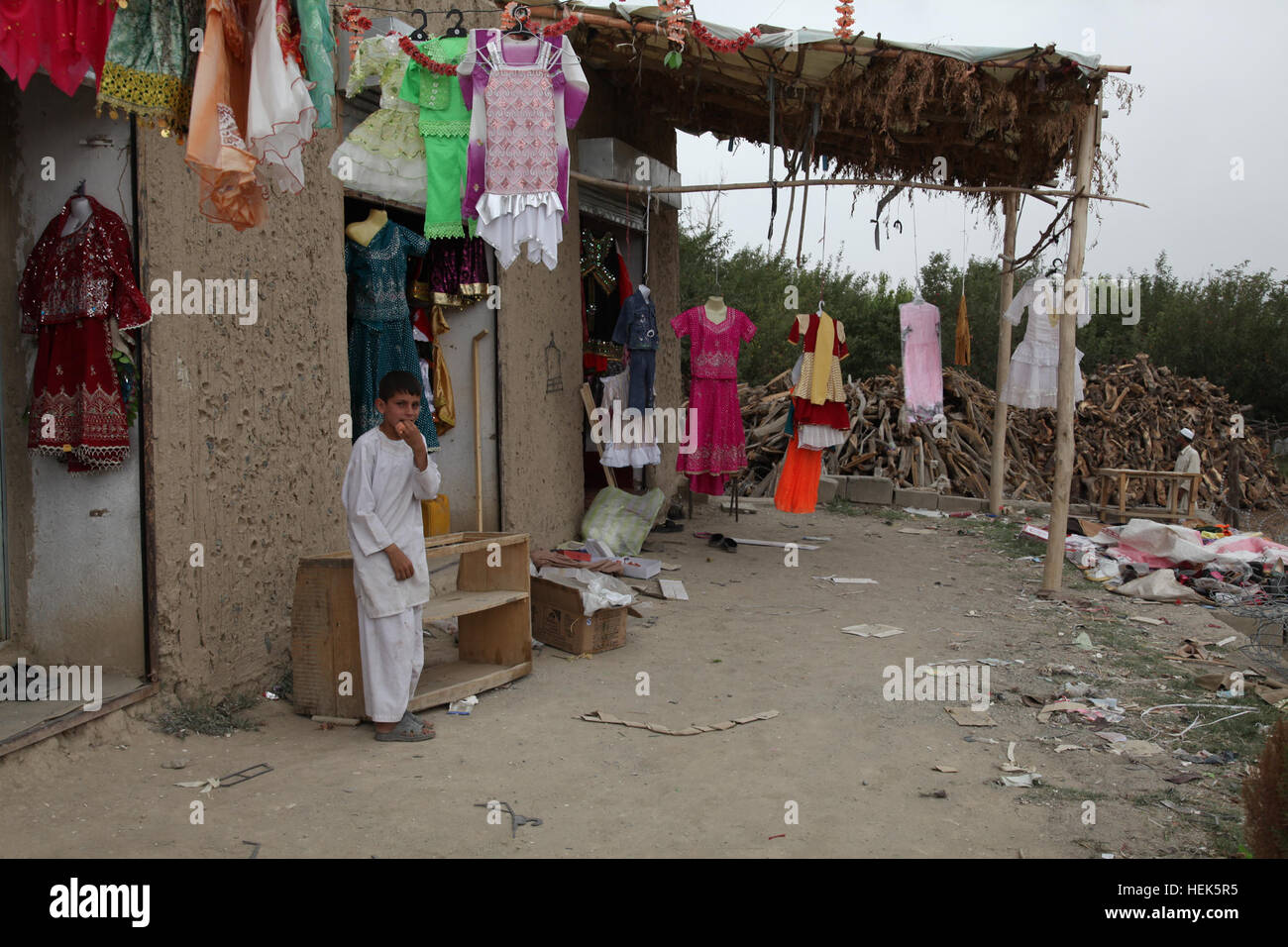 An Afghan boy stands outside a shop at the local bazaar in Sayed Abad ...