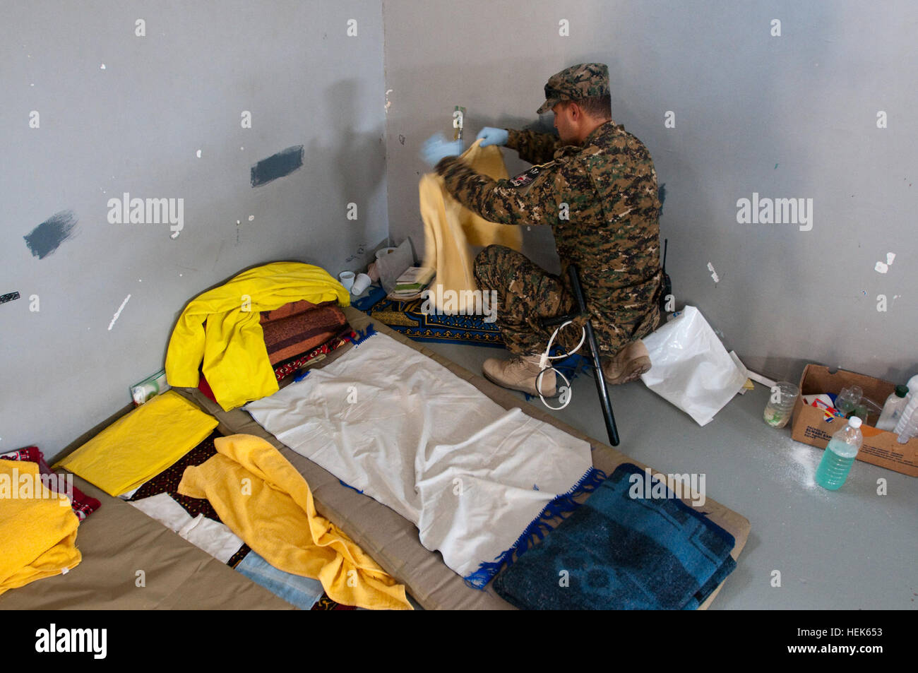 A member of the Rusafa Emergency Response Team searches an inmate's ...