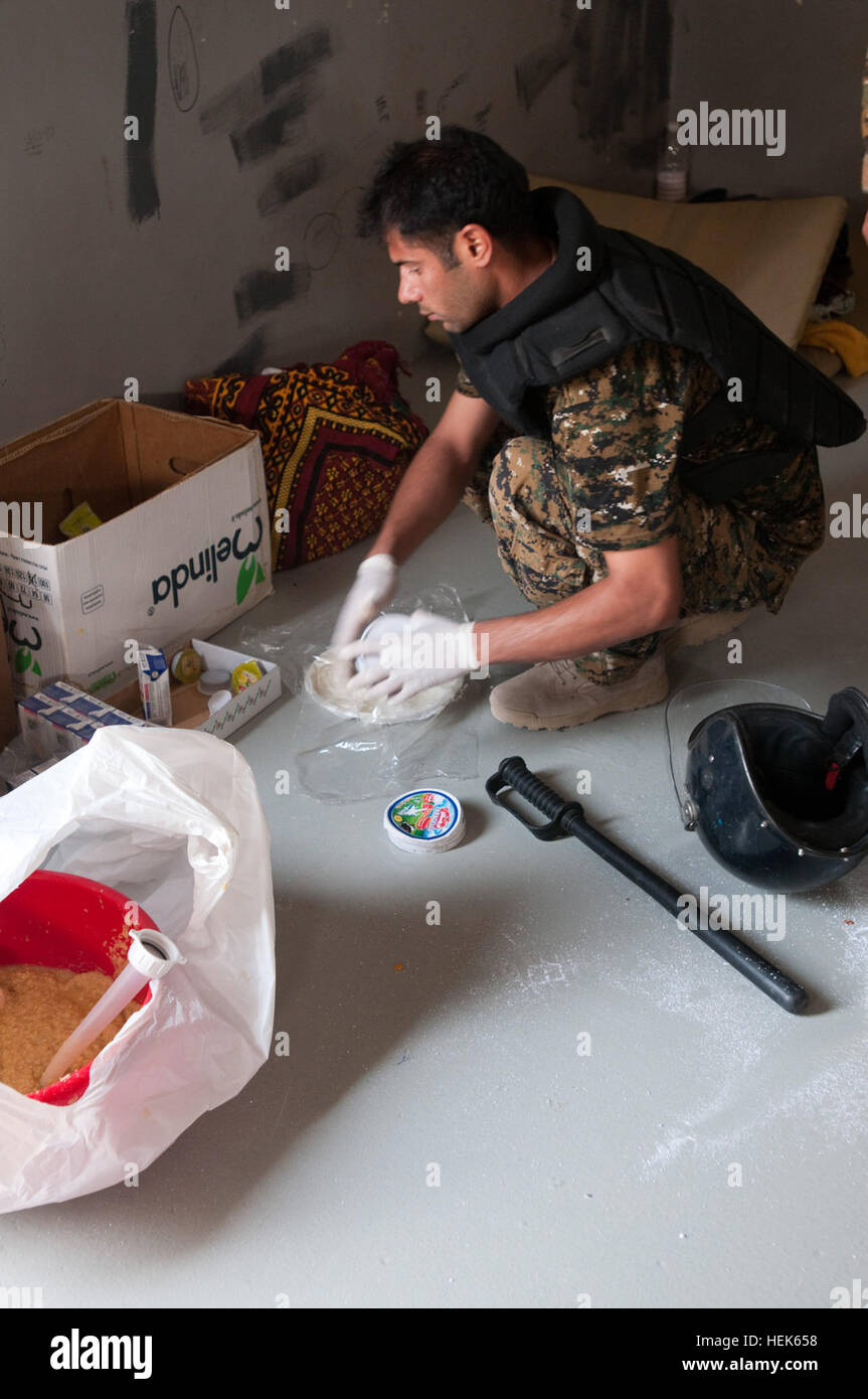 A member of the Rusafa Emergency Response Team searches an inmate's ...