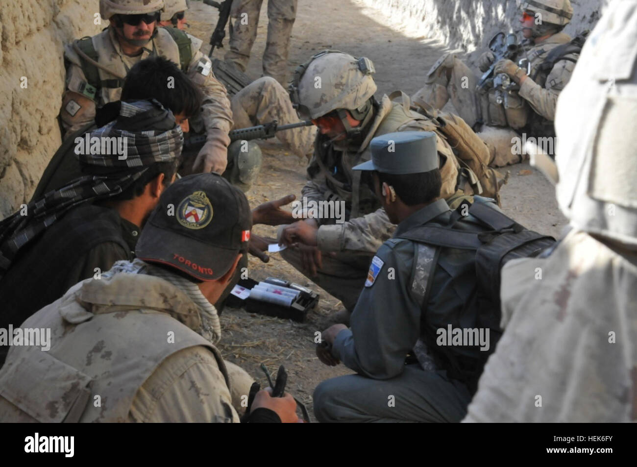 A Canadian soldier uses an explosive detection kit to test the fingers ...
