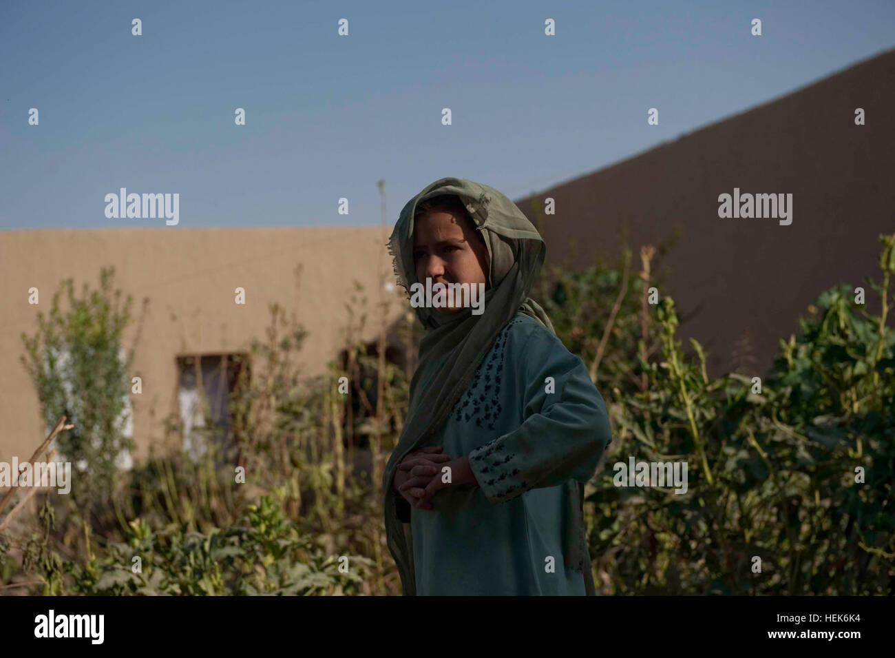 An Afghan girl looks on as policemen with 2nd Battalion, 3rd Afghan ...