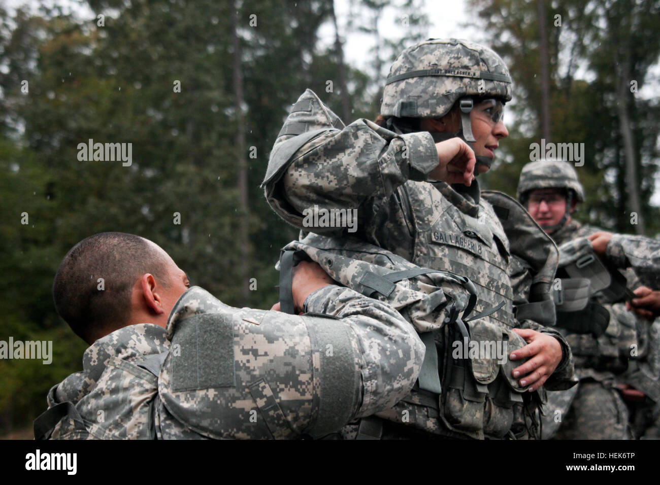 U.S. Army Staff Sgt. Russell L. Kojo helps Sgt. Sherri Gallagher with ...