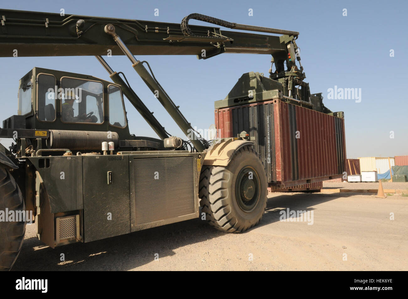 A soldier with the 724th Engineer Battalion moves a shipping container ...