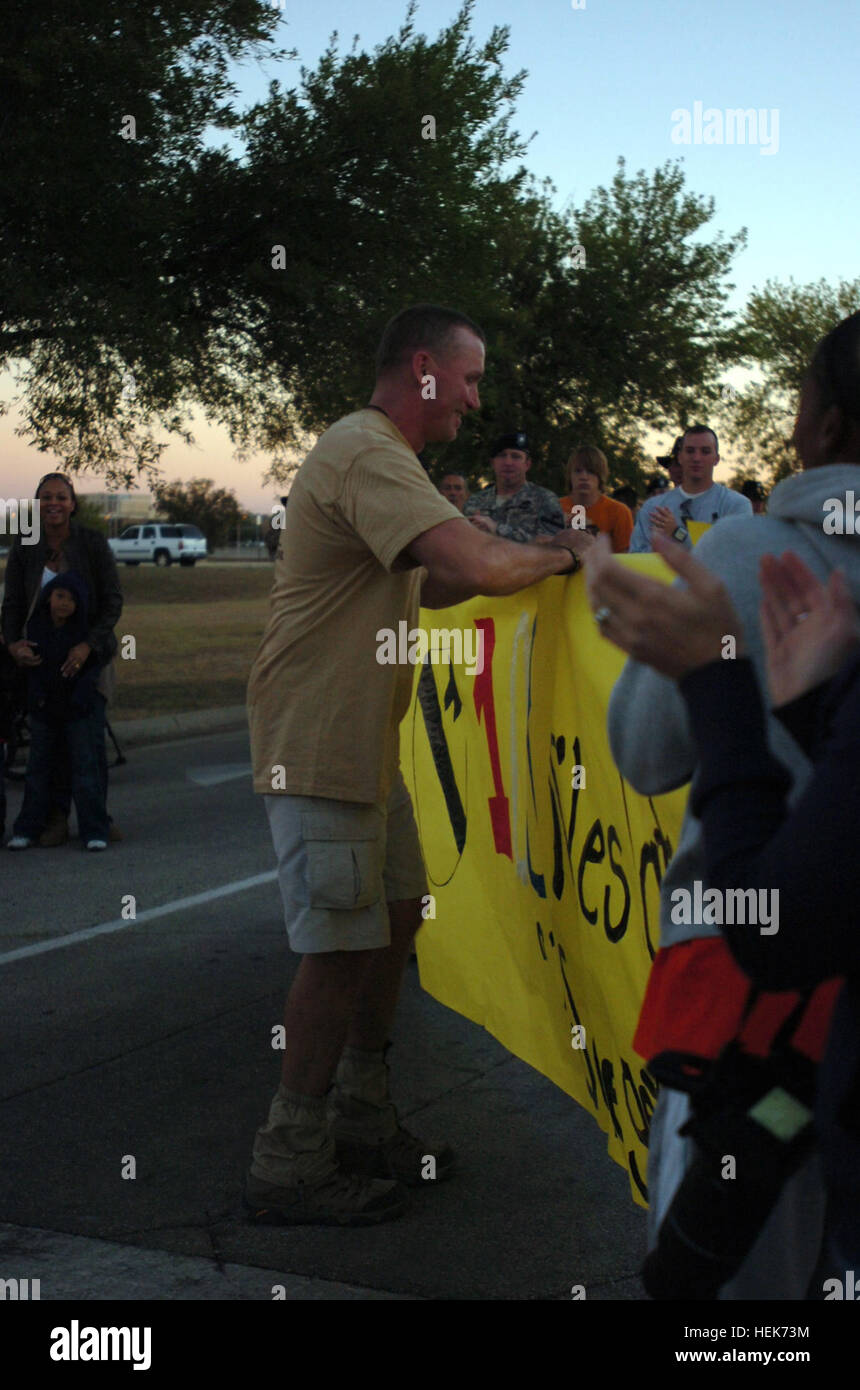 Lt. Col. Jack Usrey rips through the finish line as he completes a 100 ...