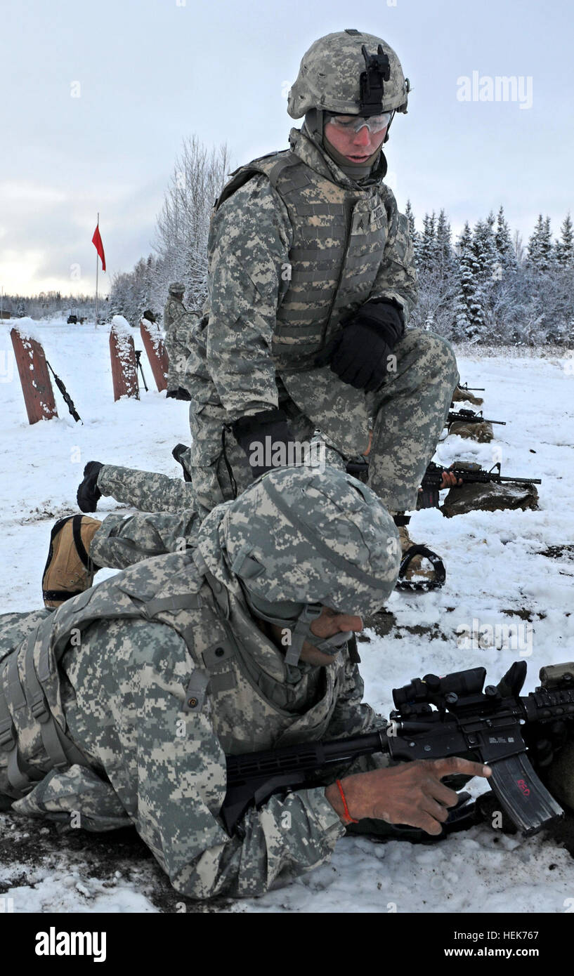 U.S. Army Sgt. Galan Carter helps an Indian soldier with his M-4 ...