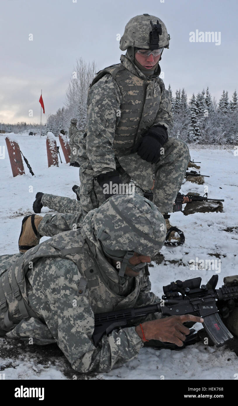U.S. Army Sgt. Galan Carter, top, teaches an Indian army soldier how to ...
