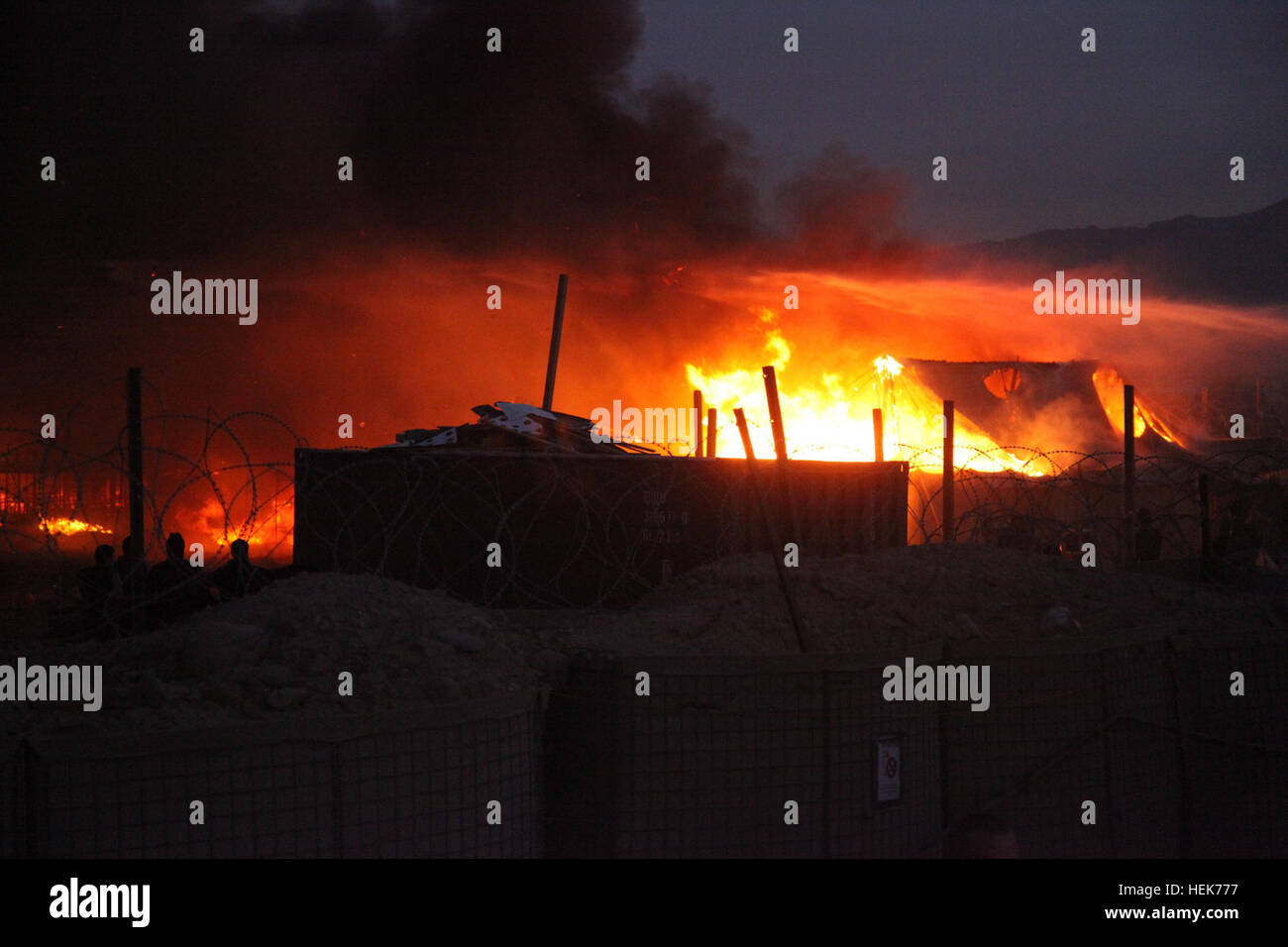 Water is sprayed over a fire at the Afghan National Army compound at ...