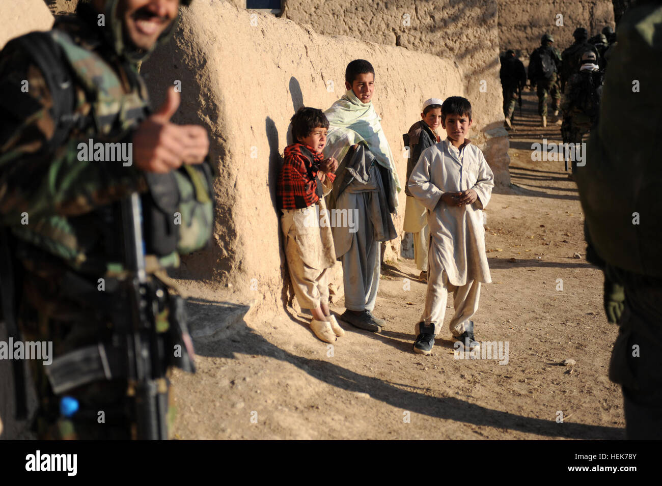 Afghan children watch as Afghan Commandos from 2nd Commando Kandak ...