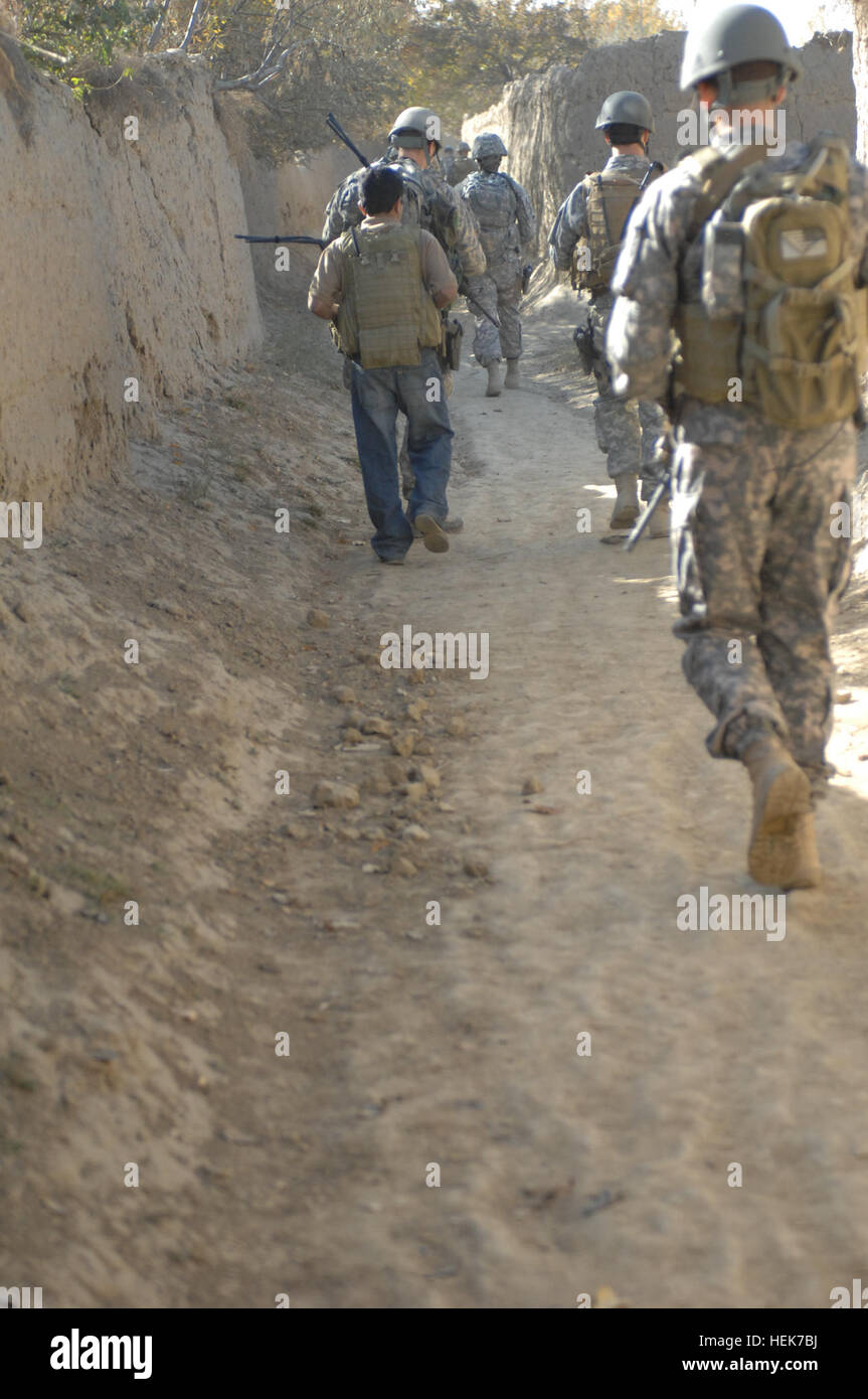 Soldiers from Special Operations Task Force-East walk on a trail ...