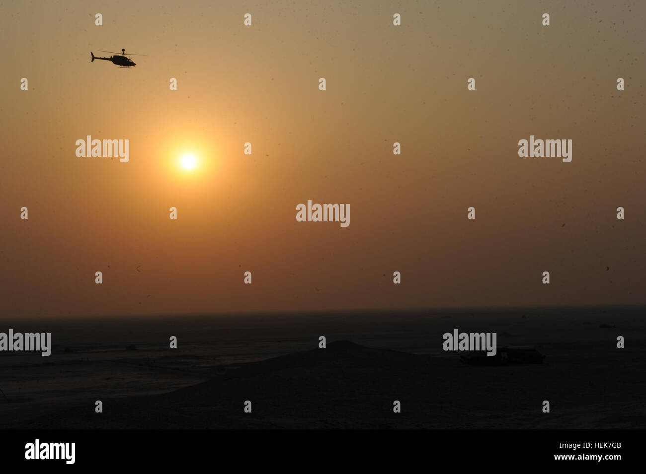 U.S. soldiers maneuver an OH-58 Kiowa Warrior helicopter across the ...