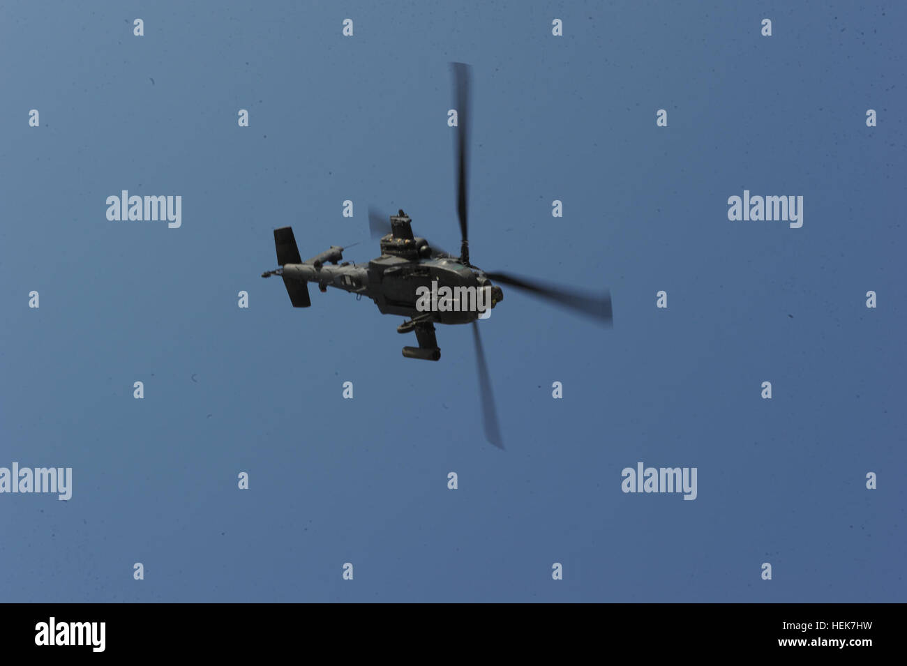 U.S. soldiers maneuver an AH-64 Apache Longbow across the desert of ...