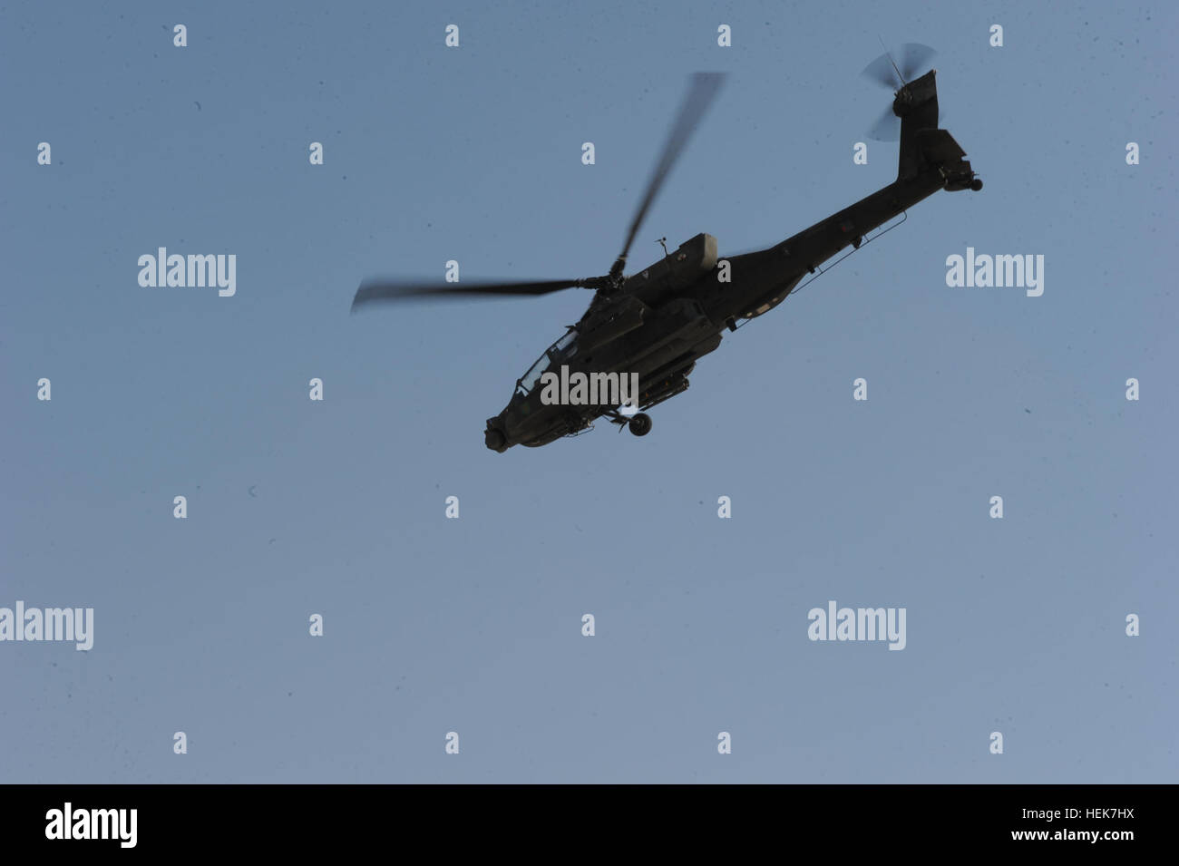 U.S. soldiers maneuver an AH-64 Apache Longbow across the desert of the ...