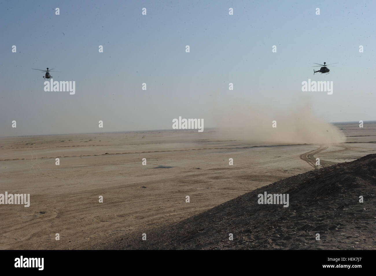 An OH-58D Kiowa Warrior moves across the desert of the Besmaya Range ...