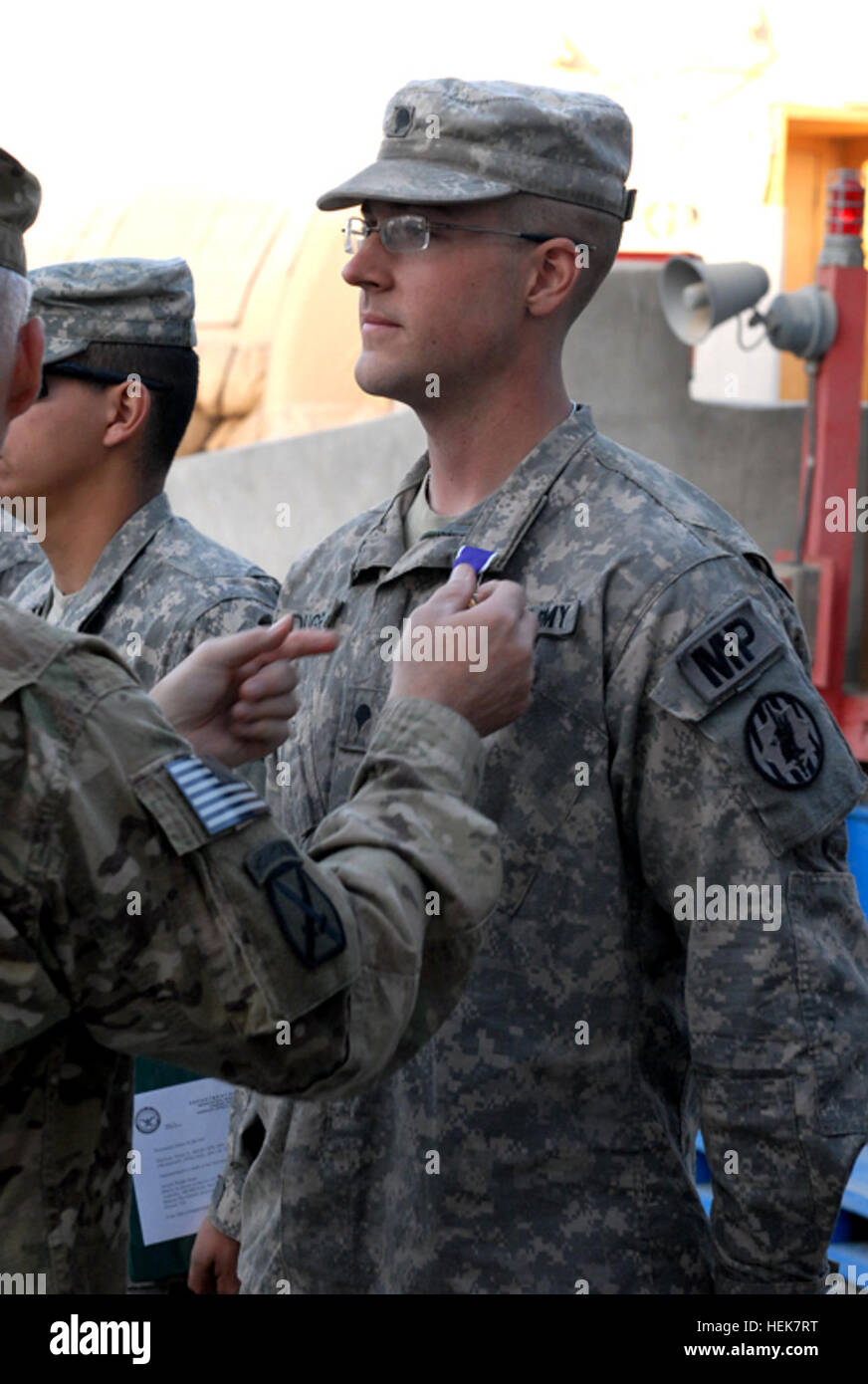 Spc. William Duggan with 202nd Military Police Company receives a ...