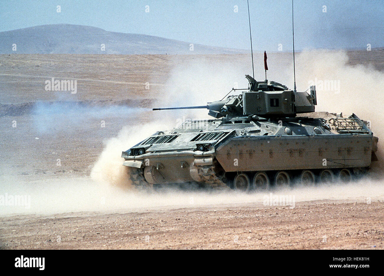 An M-2 Bradley infantry fighting vehicle fires its M-242 25mm main gun ...