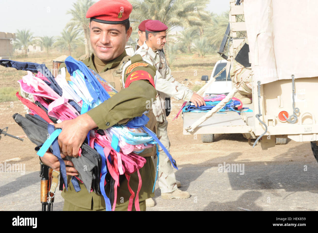 Iraqi soldiers unload backpacks filled with school supplies in Fallujah ...