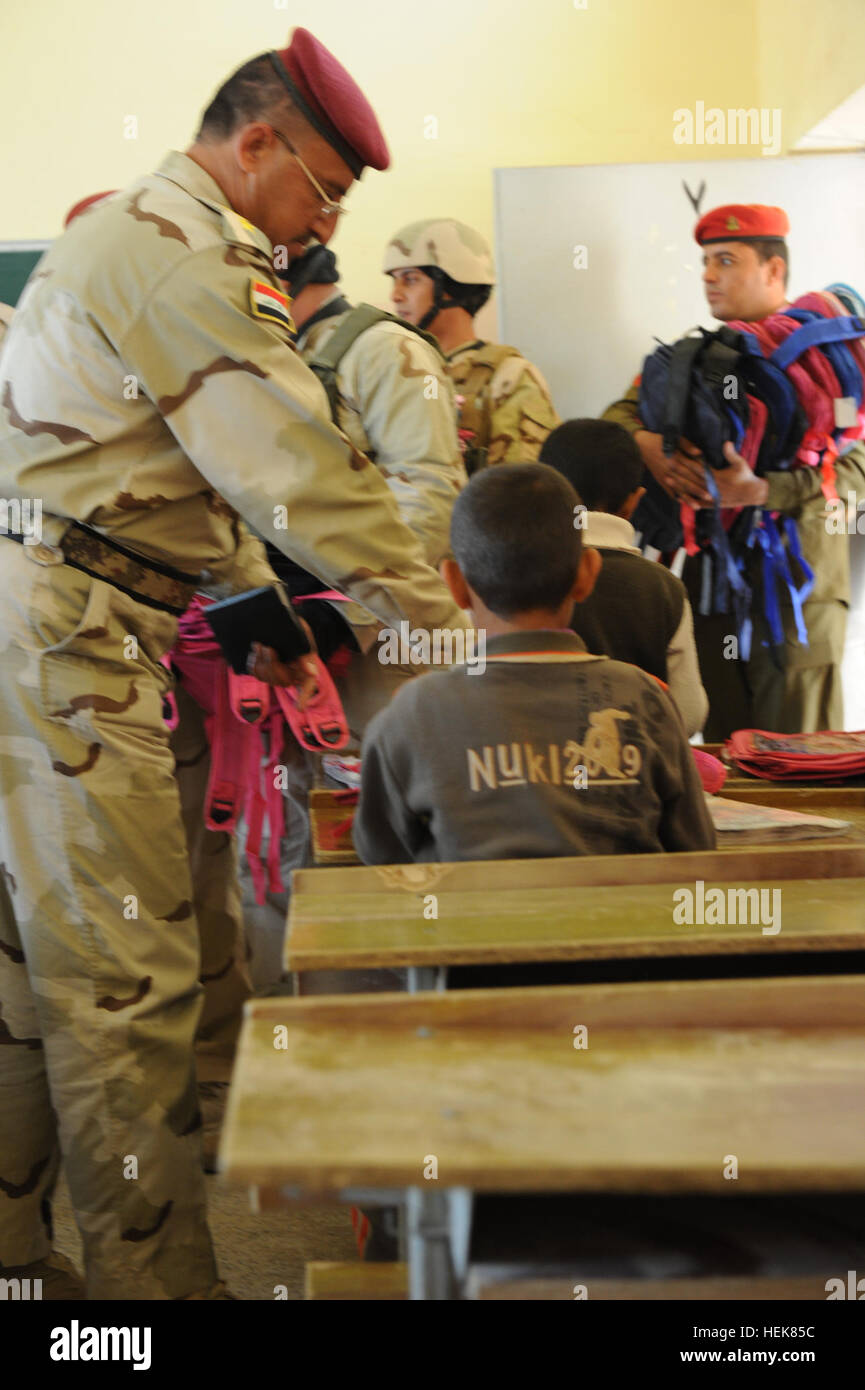 Iraqi soldiers distribute backpacks filled with school supplies to ...