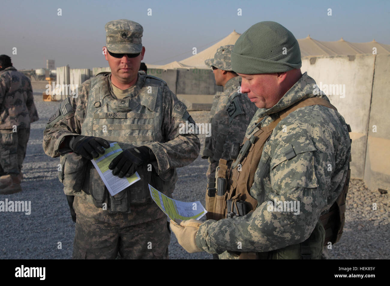 U.S. Army Staff Sgt. Gary Baker, left, waits as Lt. Col. David Haugh ...