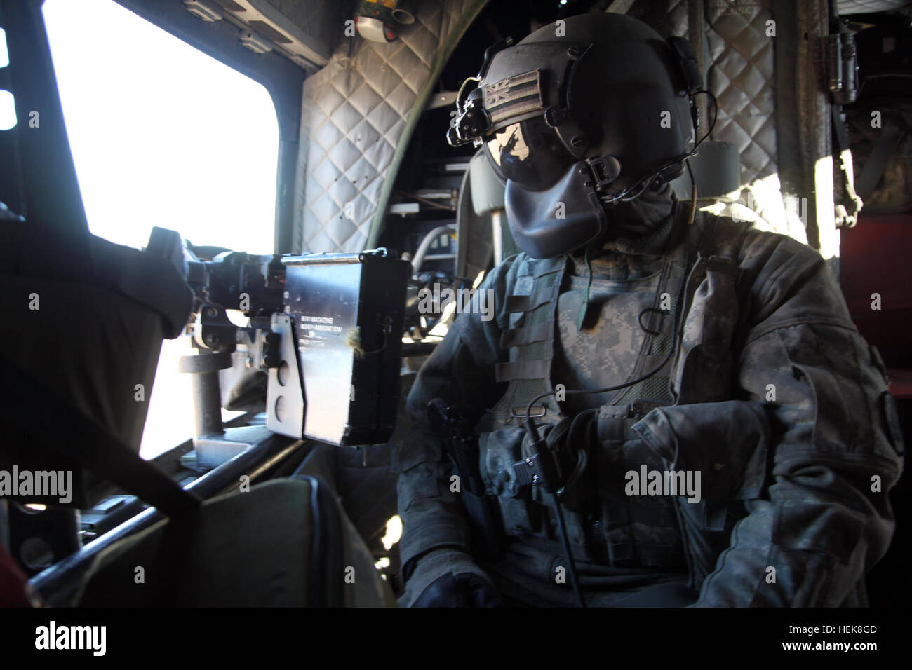 A CH-47 Chinook helicopter crew chief watches the terrain during an air ...