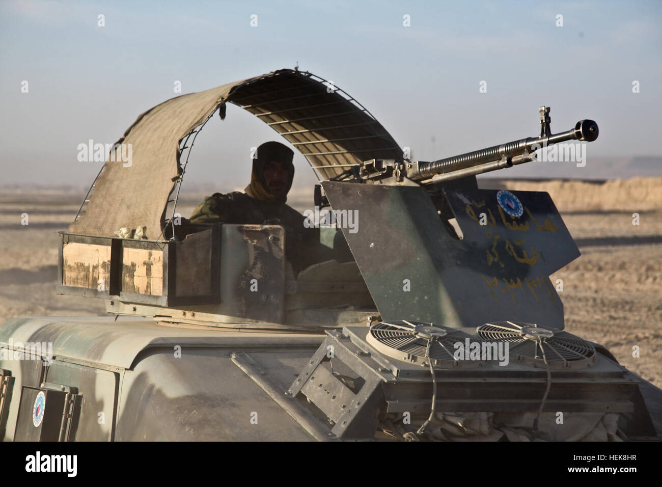 An Afghan National Army soldier sits in the gunner turret of his ...