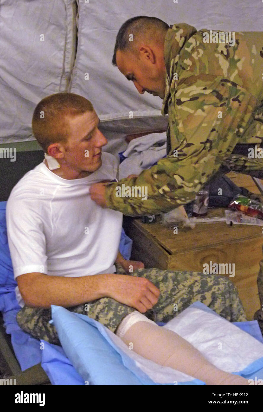 U.S. Army Spc. Ward Savage (left), an explosive ordnance disposal ...
