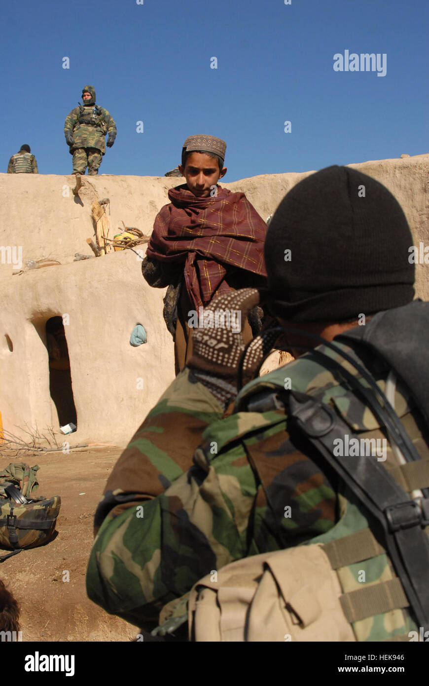 An Afghan Commando from 2nd Company, 3rd Commando Kandak, talks to an ...