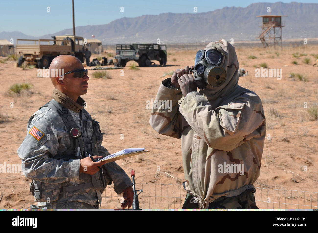 U.S. Army Staff Sgt. Jason Bierschbach, right, dons an M-40 field ...