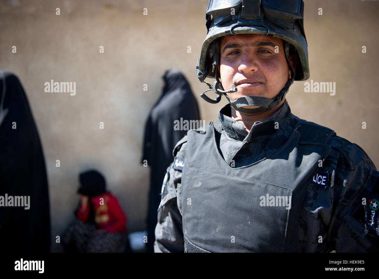 A Iraqi Police officer provides security during a humanitarian aid drop ...