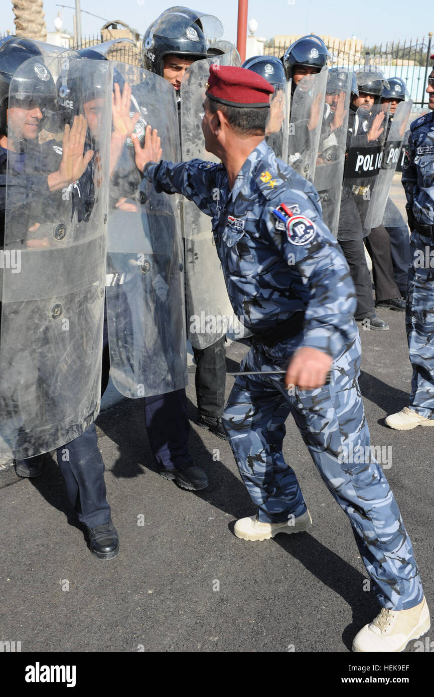 An Iraqi Police officer tests the foundation of fellow officers during ...