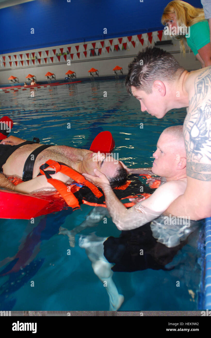 U.S. Soldiers practice rescuing a simulated casualty on a back board ...