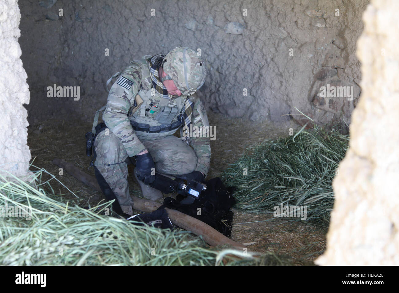 U.S. Army cavalry scouts use a portable explosion detector to search a ...