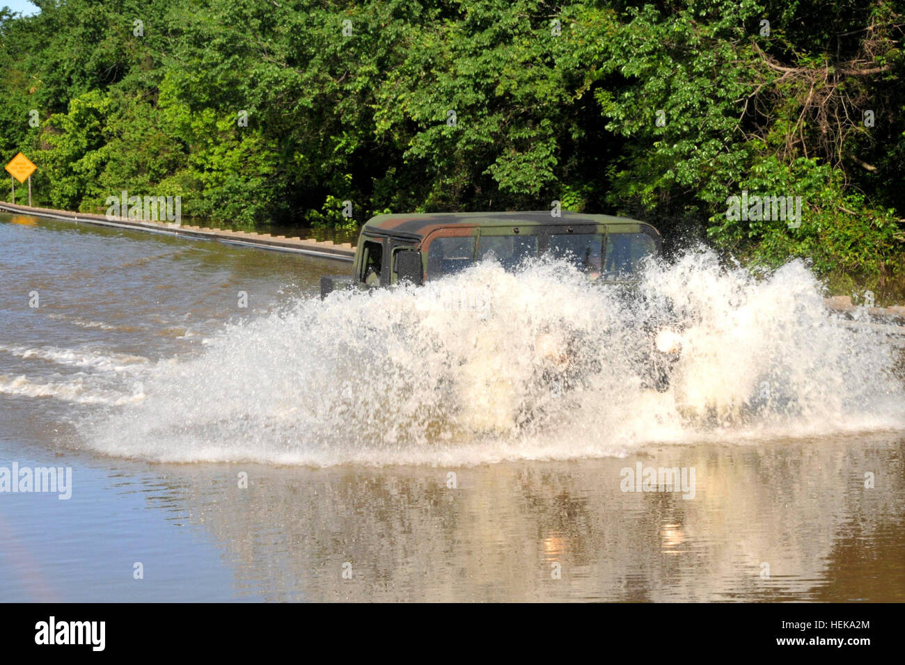 An Arkansas National Guard humvee passes through high water along a ...