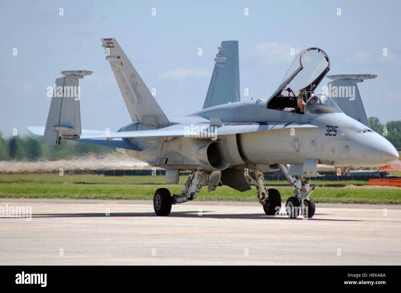 The Pilot of an F-18 Hornet lands his plane and waves at the crowd ...
