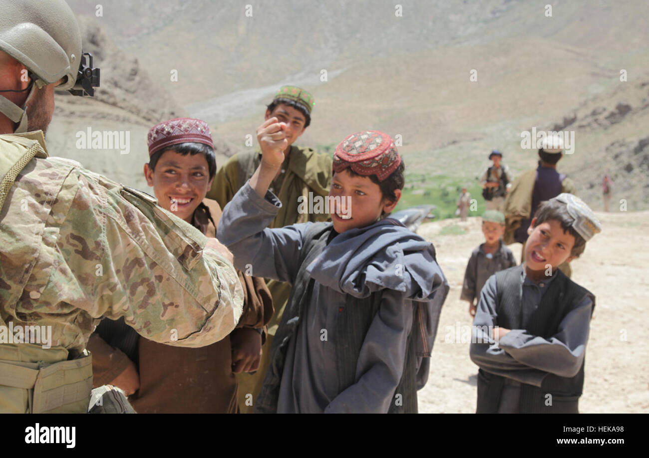A U.S. Army Special Forces Soldier speaks with villagers during a ...