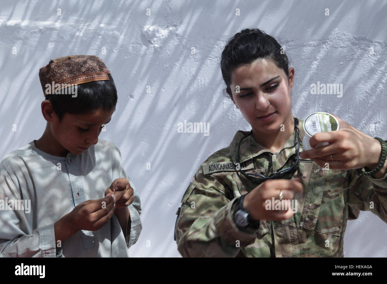 U.S. Army Spc. Lydia Admounabdfany, helps a little boy during an arts ...