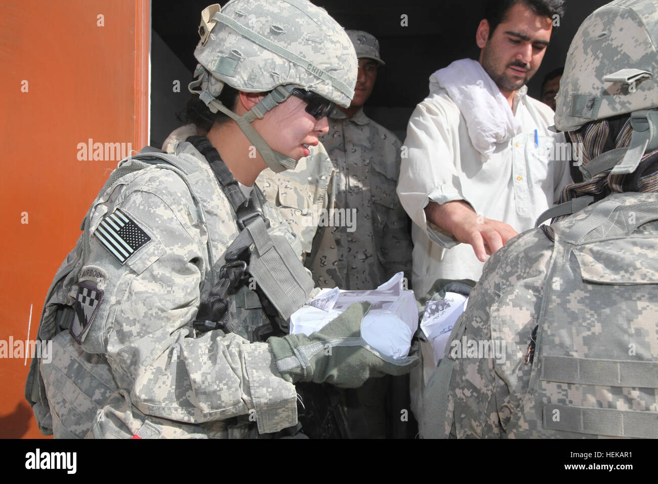 U.S. Army Capt. Vivian Chiu, Combine Task Force Lighting, give fliers ...