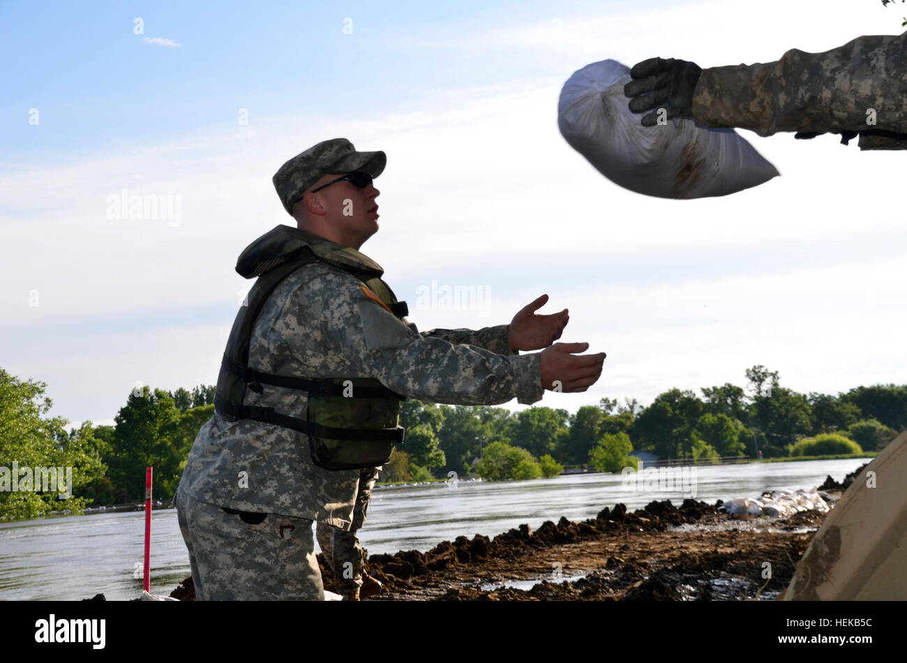 A North Dakota National Guard soldier places sandbags on a temporary ...