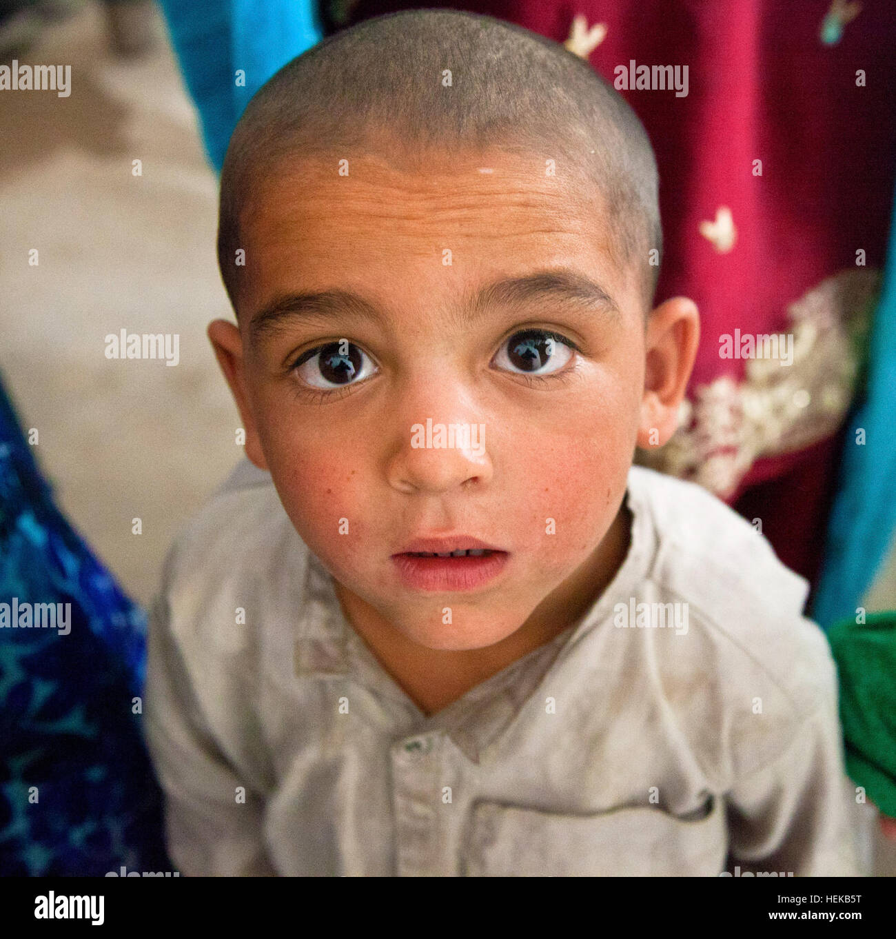 An Afghan boy stares into the camera during a meeting at Baqi Tanah ...