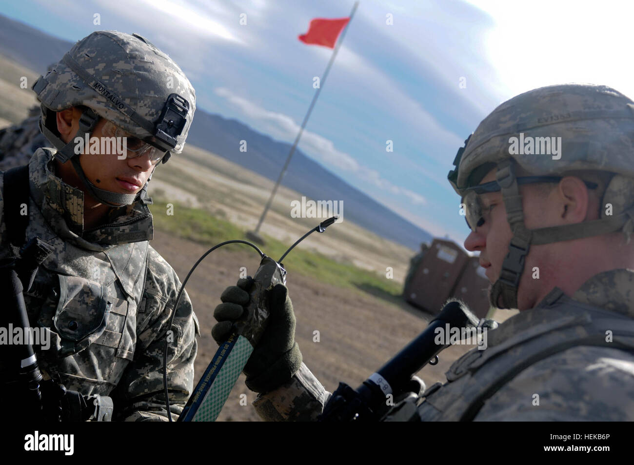 U.S. Army Pvt. Isaiah Montalvo, left, receives instruction on how to ...