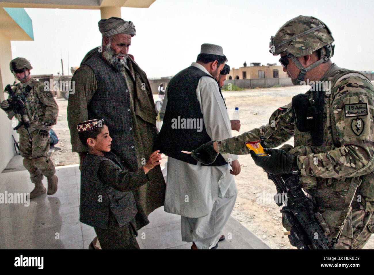 A U.S. Army soldier gives a small Afghan boy chewing gum outside the ...