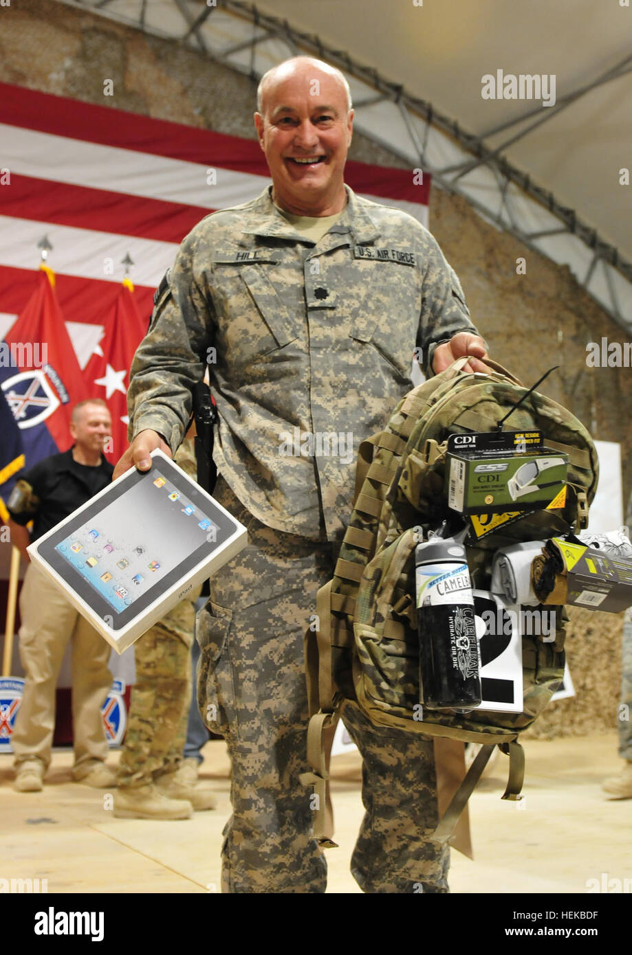A U.S. Air Force service member displays his prizes during a giveaway ...