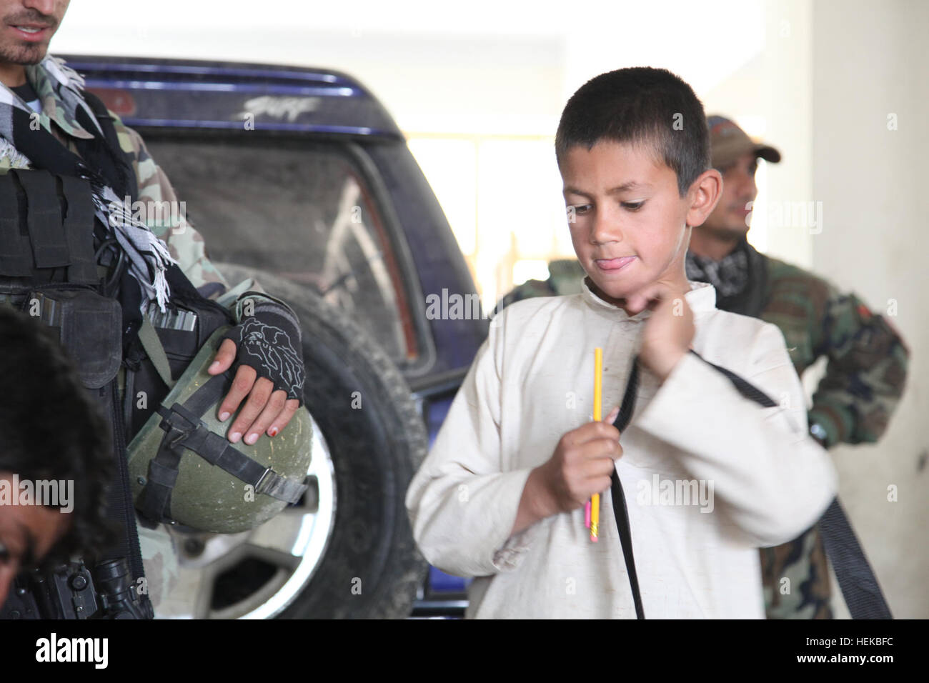 A young boy receives a backpack full of goods from Afghan Commandos ...